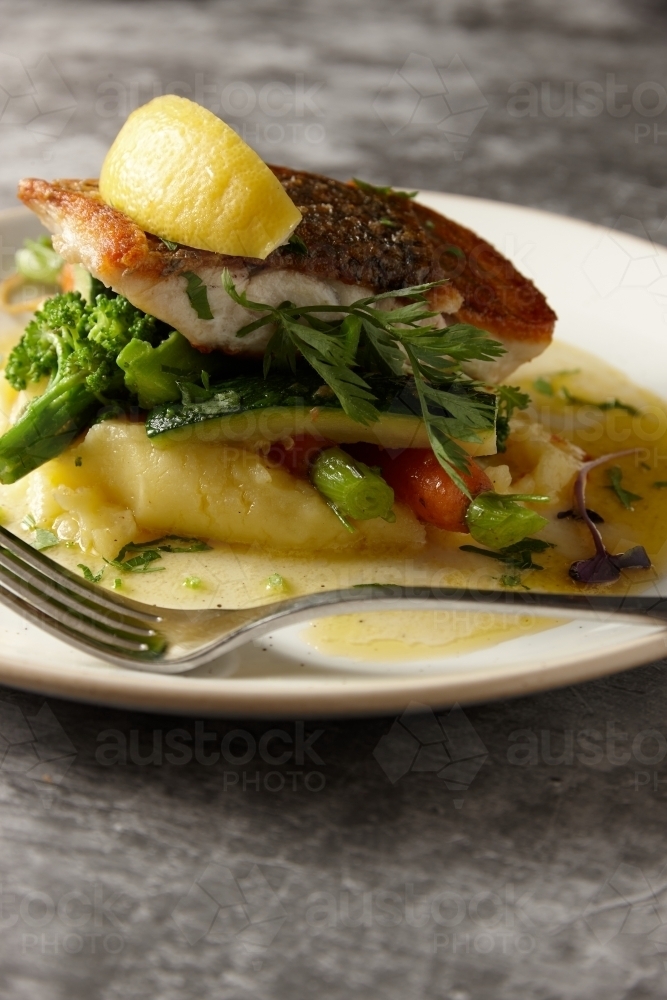 Image of Close up of delicious barramundi dish on plate - Austockphoto