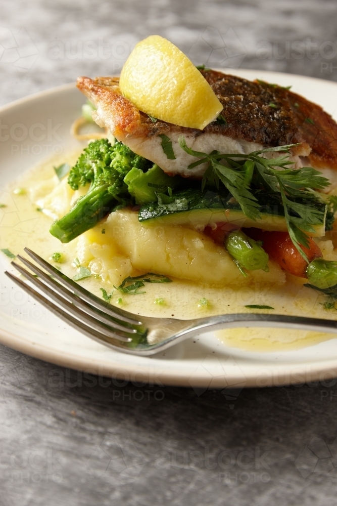 Image of Close up of delicious barramundi dish on plate - Austockphoto