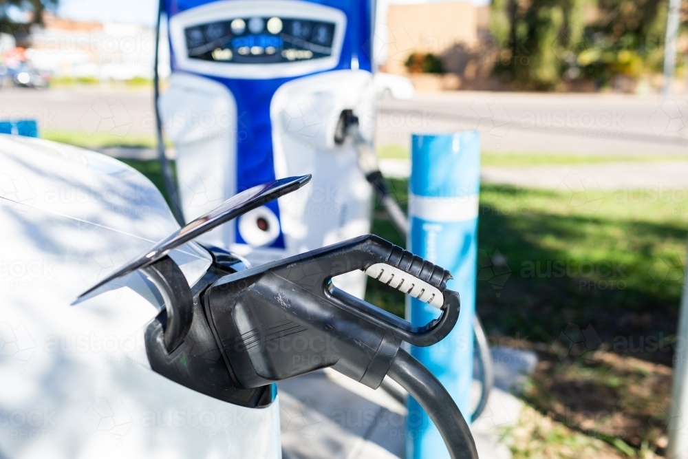Image of Close up of Fast charging ev power plug at public charging ...