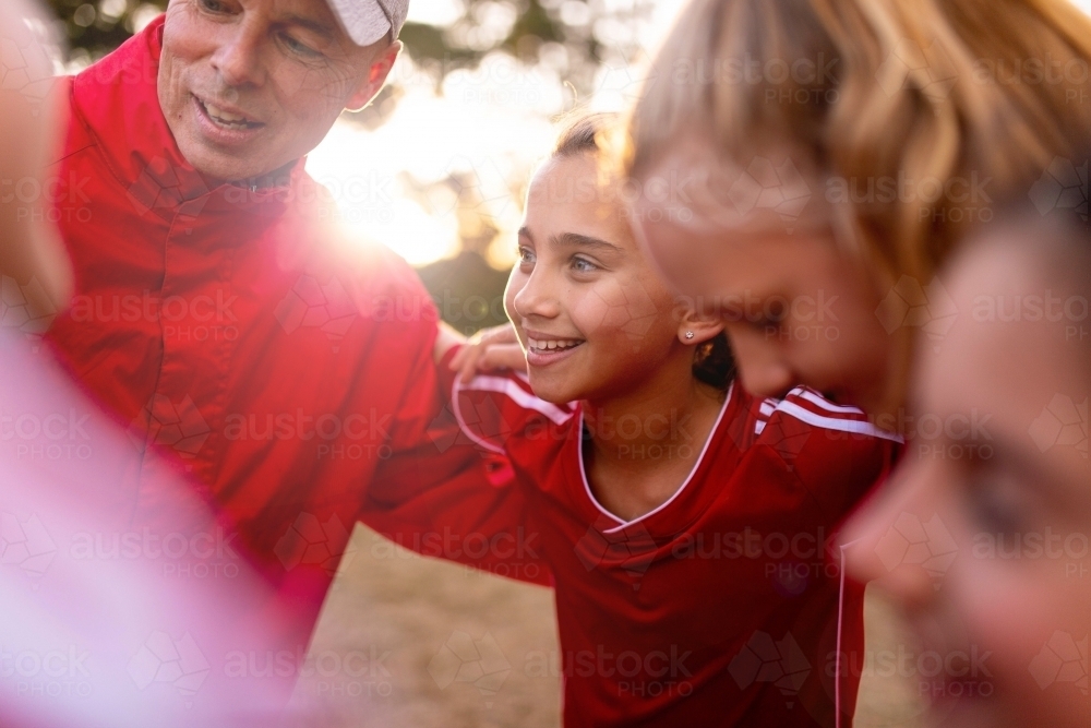 Image of Close-up of female tween football team players with coach in a ...