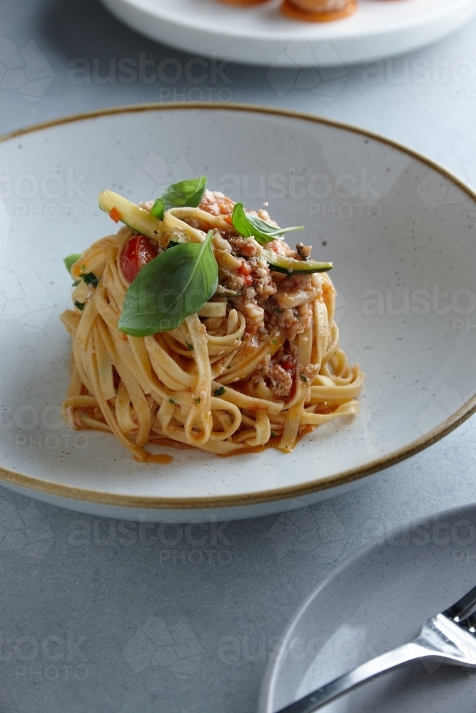 Image of Close up of fresh pasta dish on table - Austockphoto