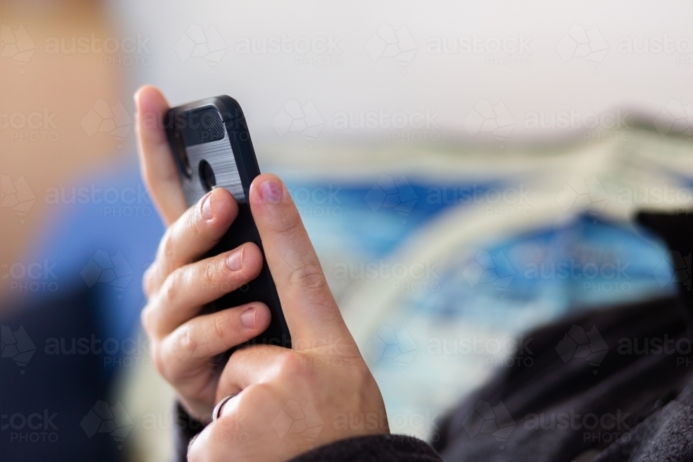 Image of Close up of hands texting on mobile phone - Austockphoto