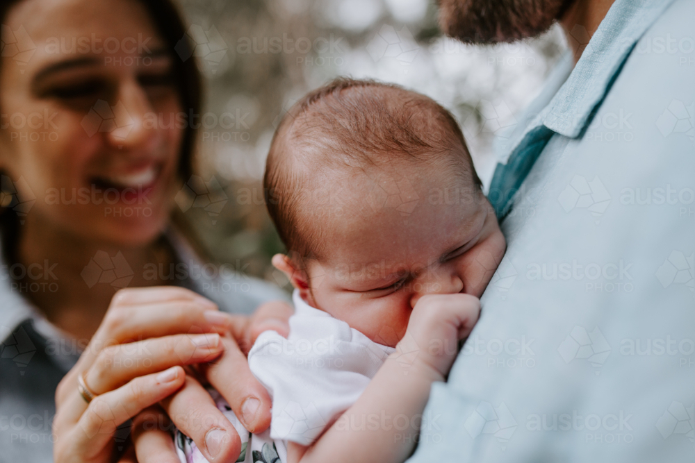 Image of Close-up of newborn baby girl sleeping on father's chest ...