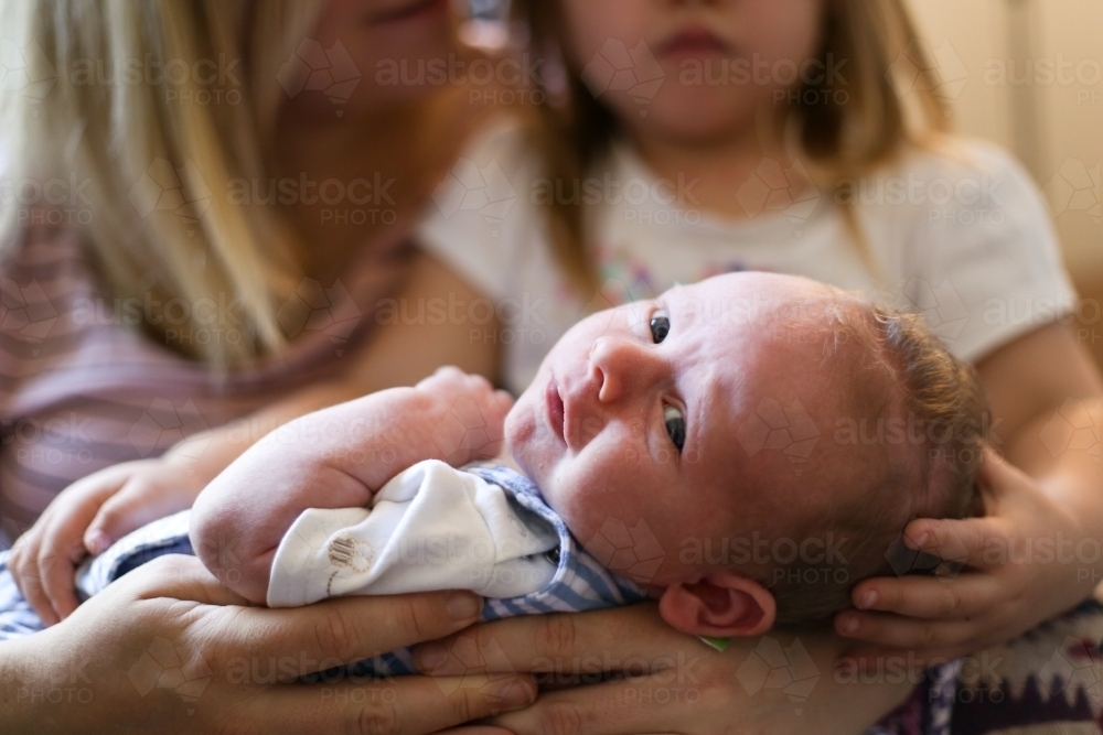 Image of Close up of newborn baby looking at camera - Austockphoto