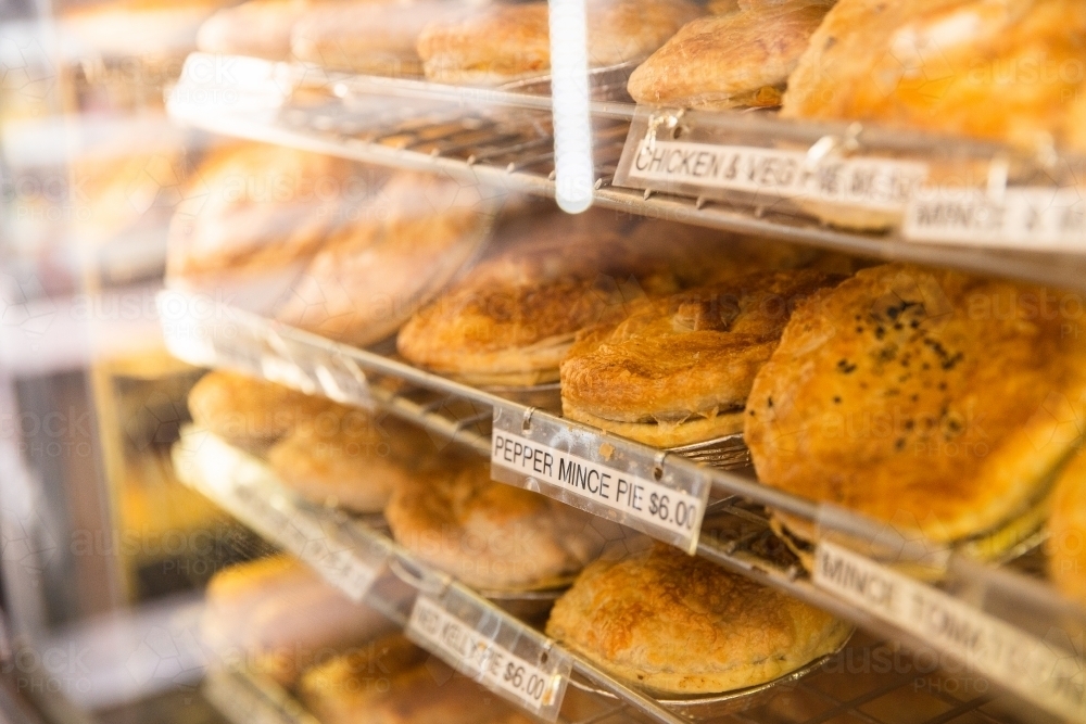 Image of close up of pies in a bakery display cabinet - Austockphoto
