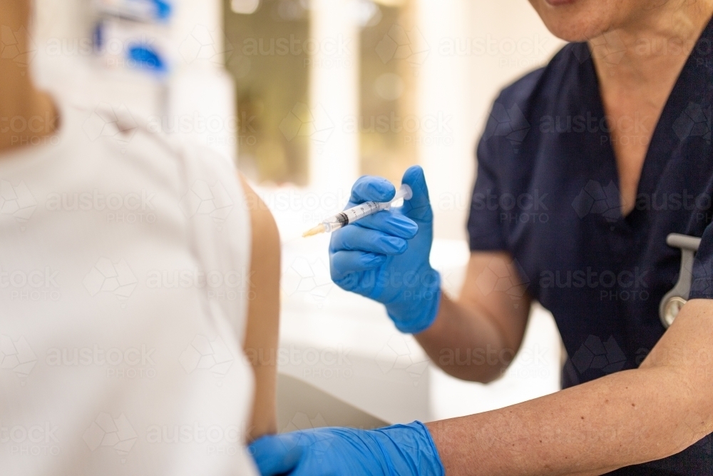 Image of Close up of shot a healthcare worker with blue gloves giving a ...