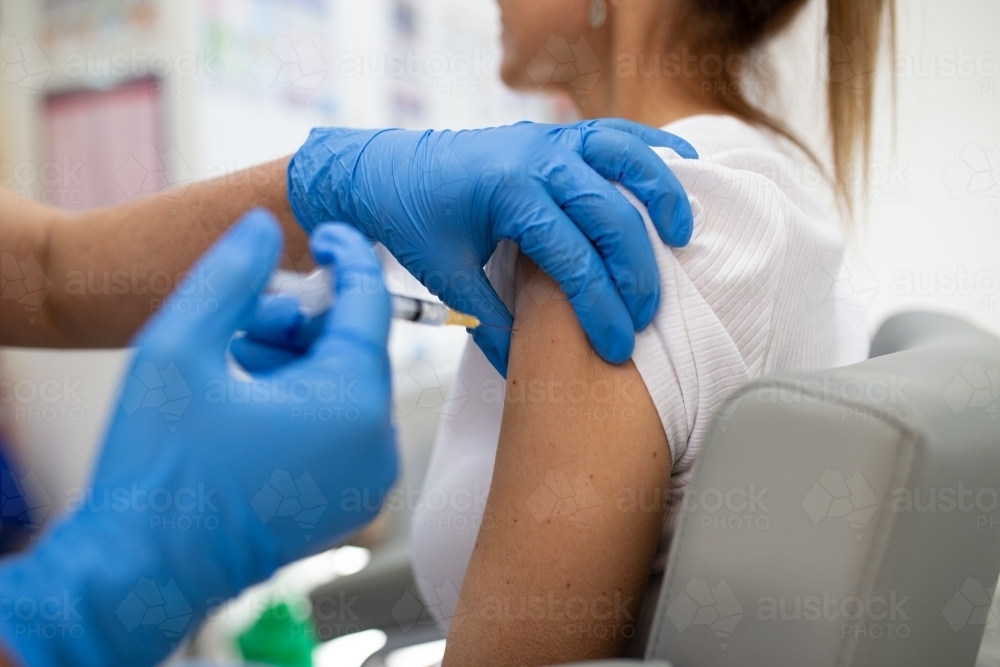 Image of Close up of shot a healthcare worker with blue gloves giving a ...