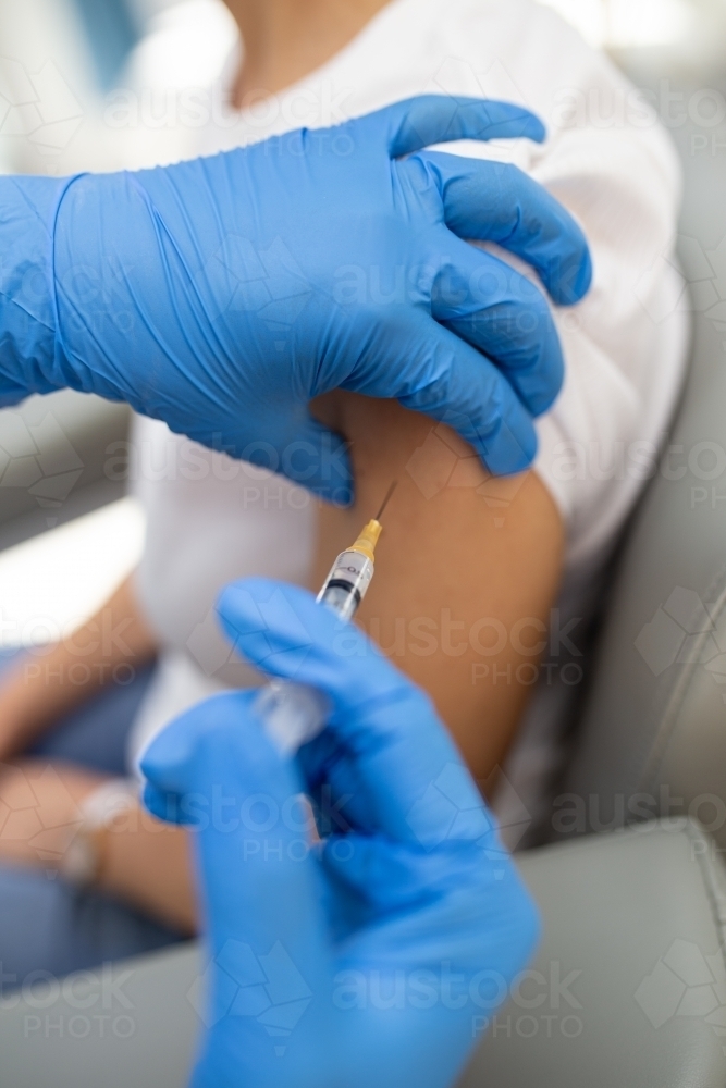 Image of Close up of shot a healthcare worker with blue gloves giving a ...
