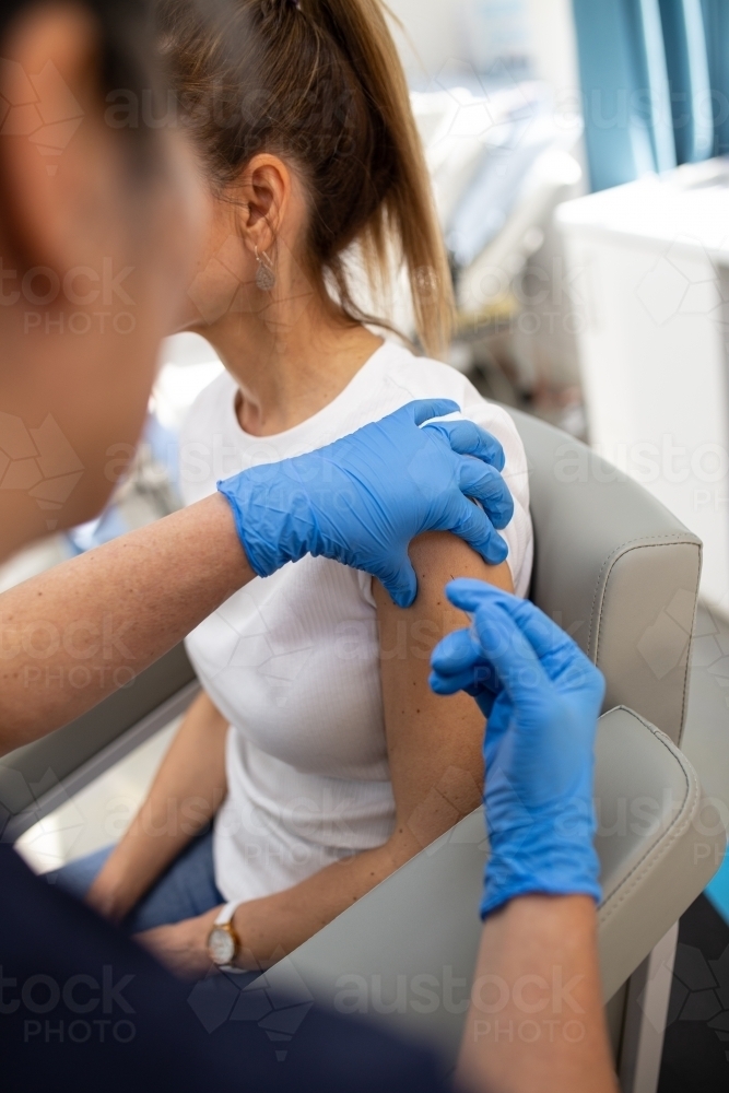Image of Close up of shot a healthcare worker with blue gloves giving a ...