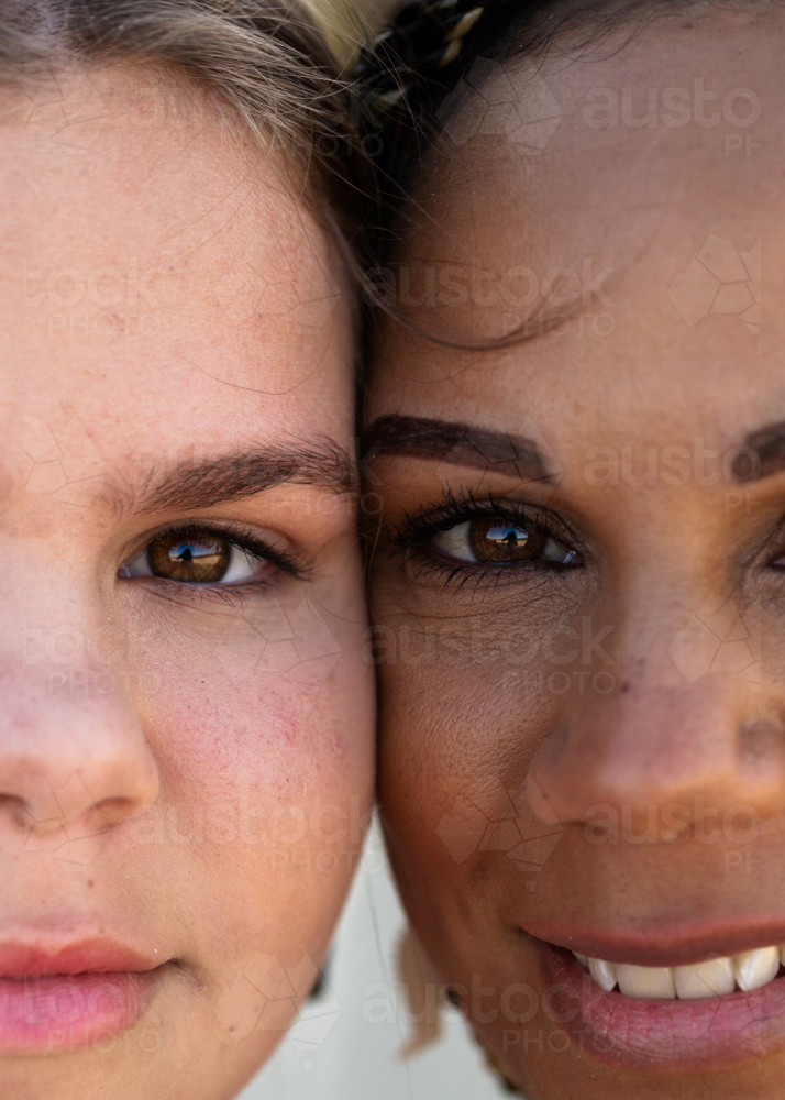 Image of Close up of Torres Strait Islander mother and daughters brown eyes. - Austockphoto