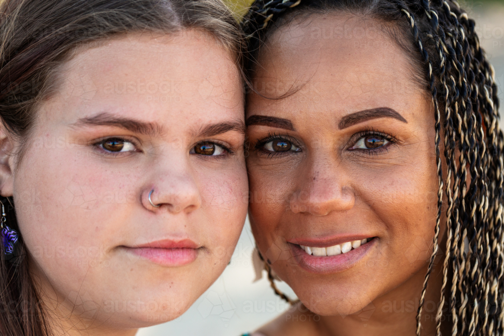 Image of Close up of Torres Strait Islander mother and daughters brown eyes. - Austockphoto