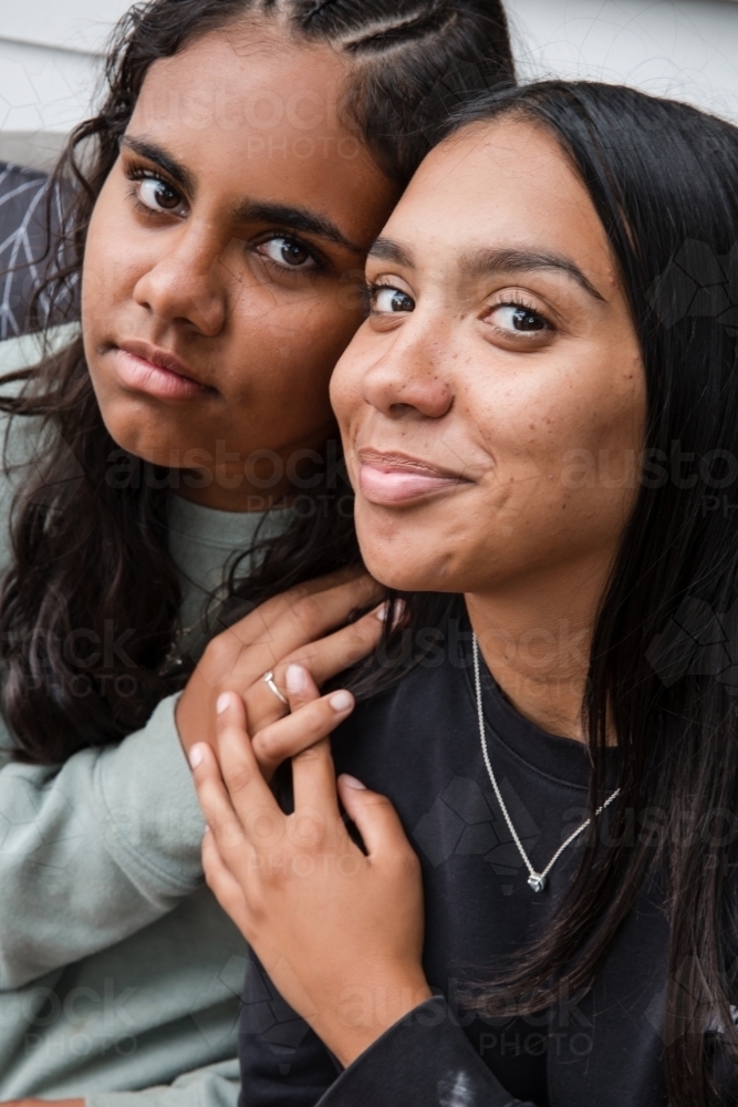 Image of Close-up of two Aboriginal girls hugging - Austockphoto