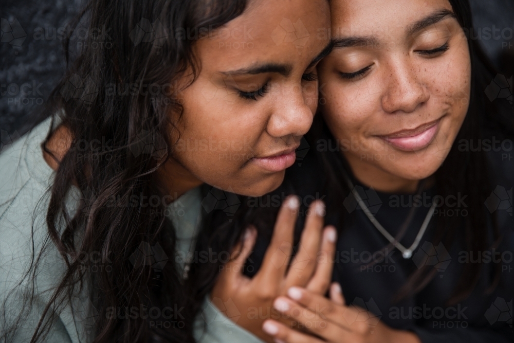 Image of Close-up of two Aboriginal girls hugging - Austockphoto