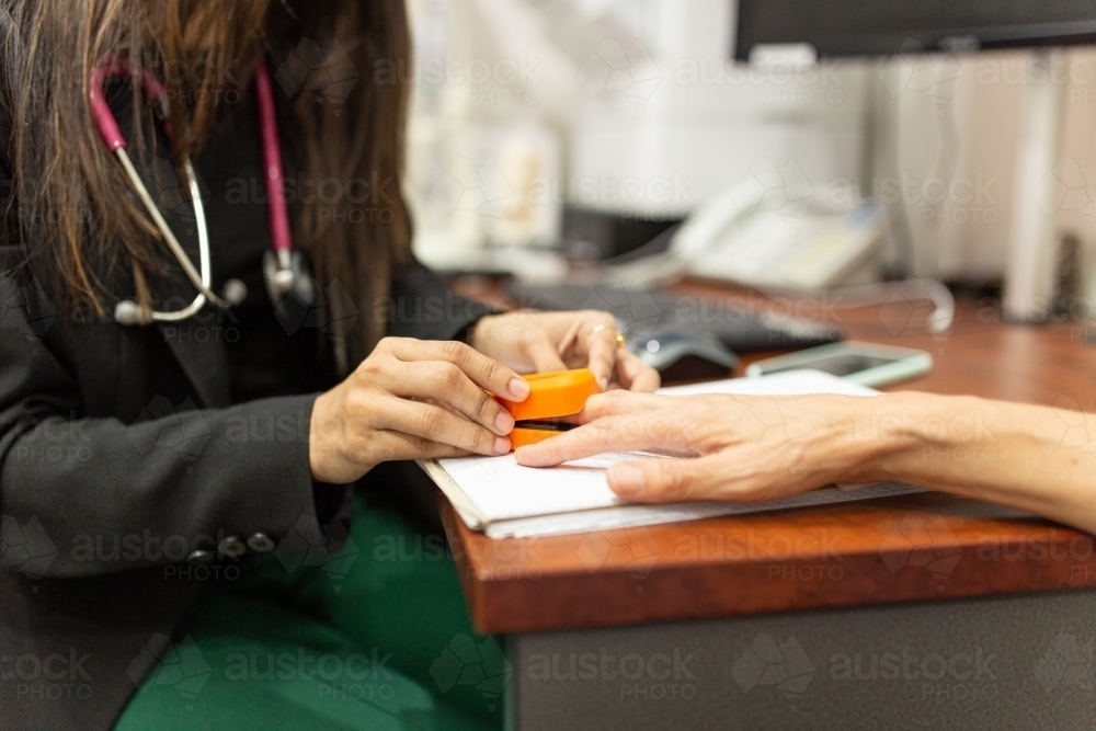 Image of close up shot of a female doctor checking a patient's pulse ...