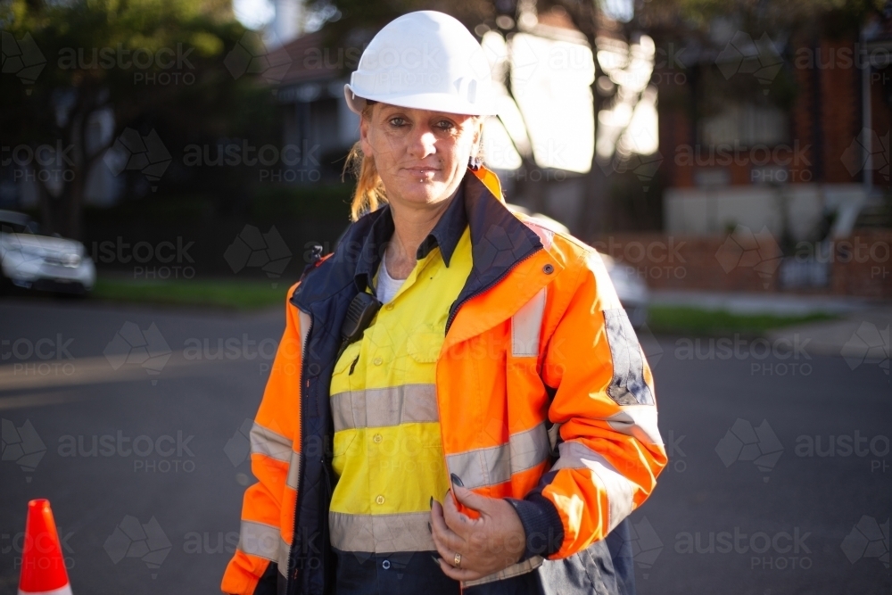 Image of Close up shot of a woman road worker with white helmet and ...