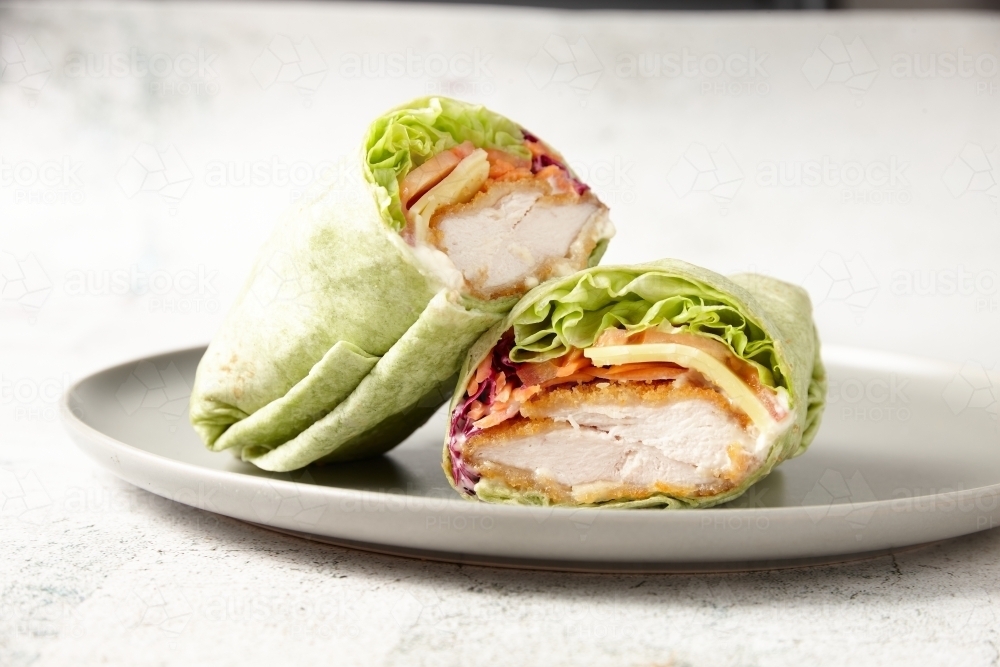 Image of close up shot of chicken schnitzel wrap - Austockphoto