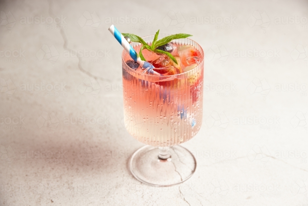 Image of Close up shot of pink lemonade with white and blue striped ...