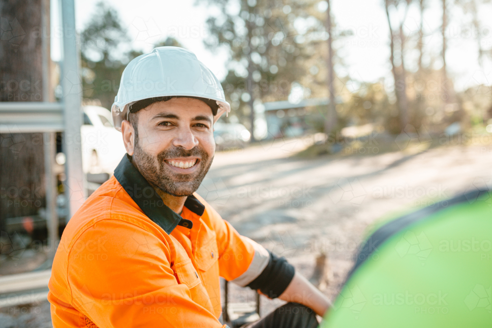 Image of Closeup of a construction worker sitting on the ground of the ...