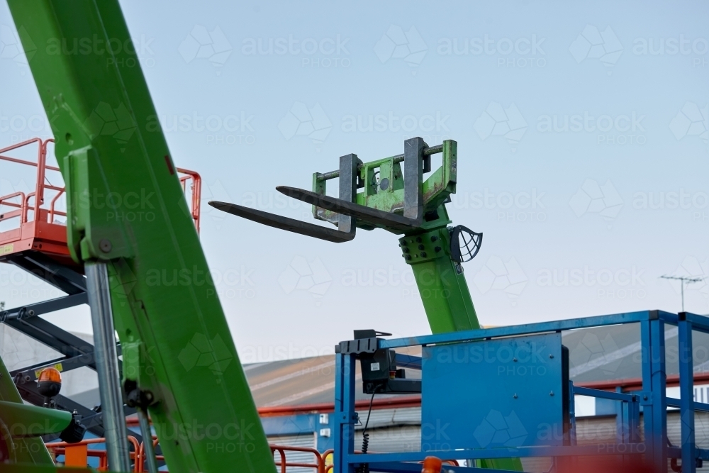 Image of closeup of green cargo fork lifter - Austockphoto