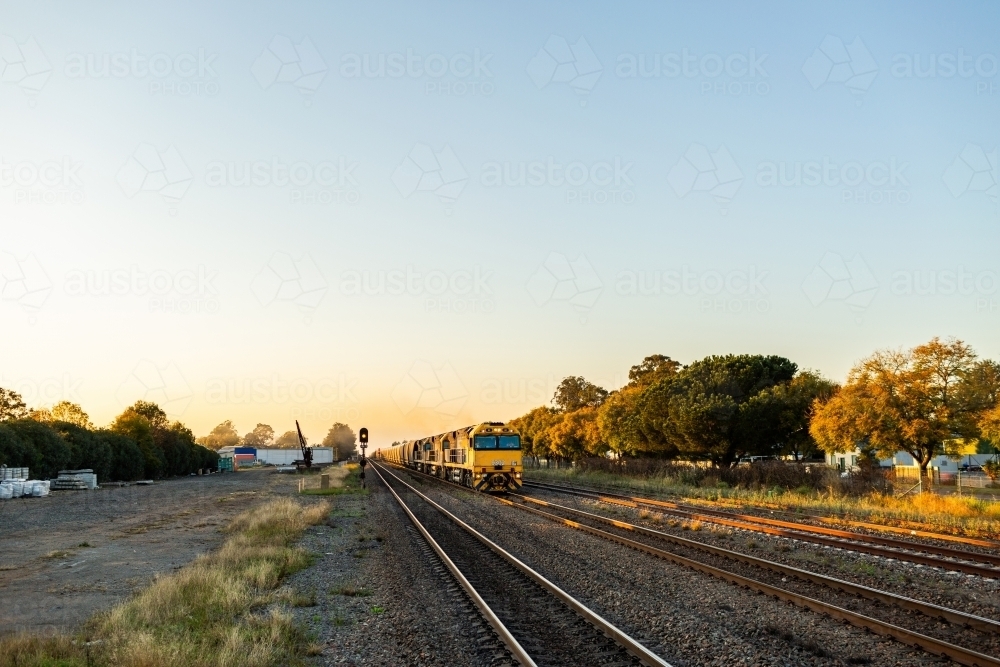 Image of Coal train approaching to pass station in Singleton in morning ...