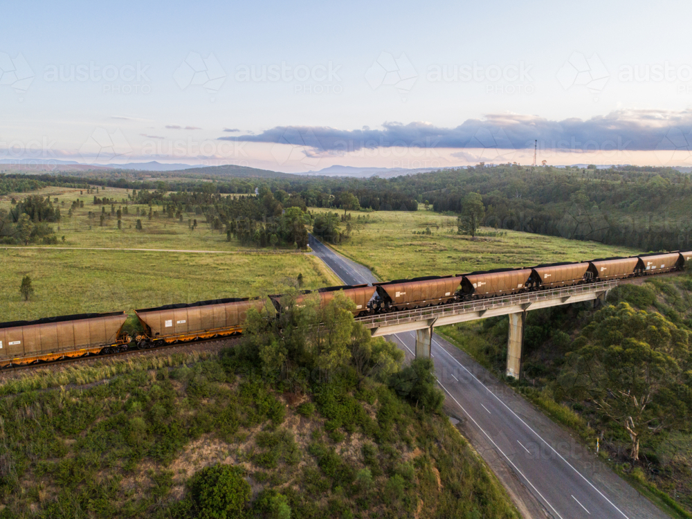 Image of Coal train full of coal crossing over railway bridge over ...