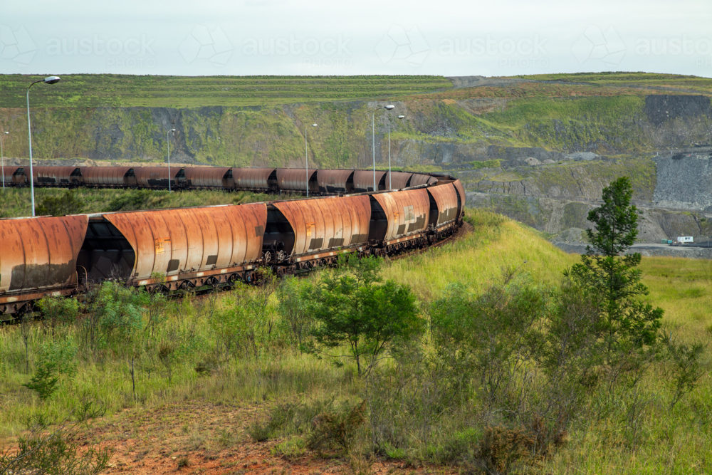 Image of Coal train turning bend on railroad in front of mine ...