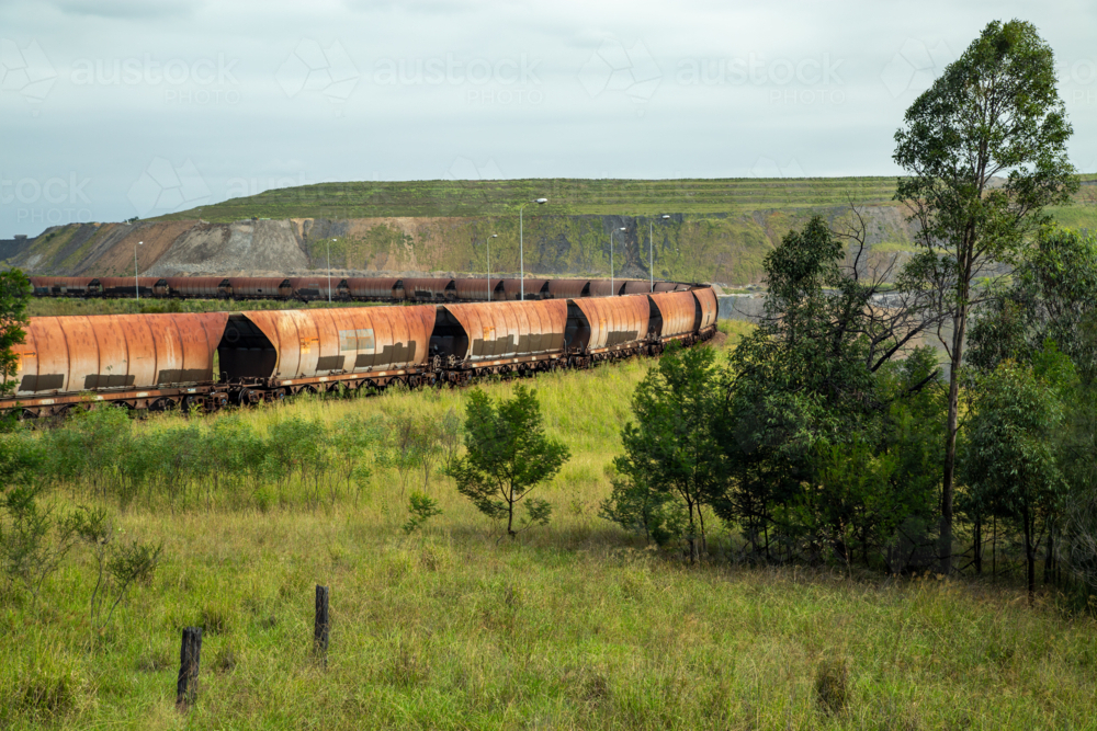 Image of Coal train turning bend on railroad in front of mine ...