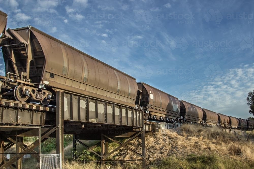 Image of Coal trains hauling coal and crossing a bridge - Austockphoto
