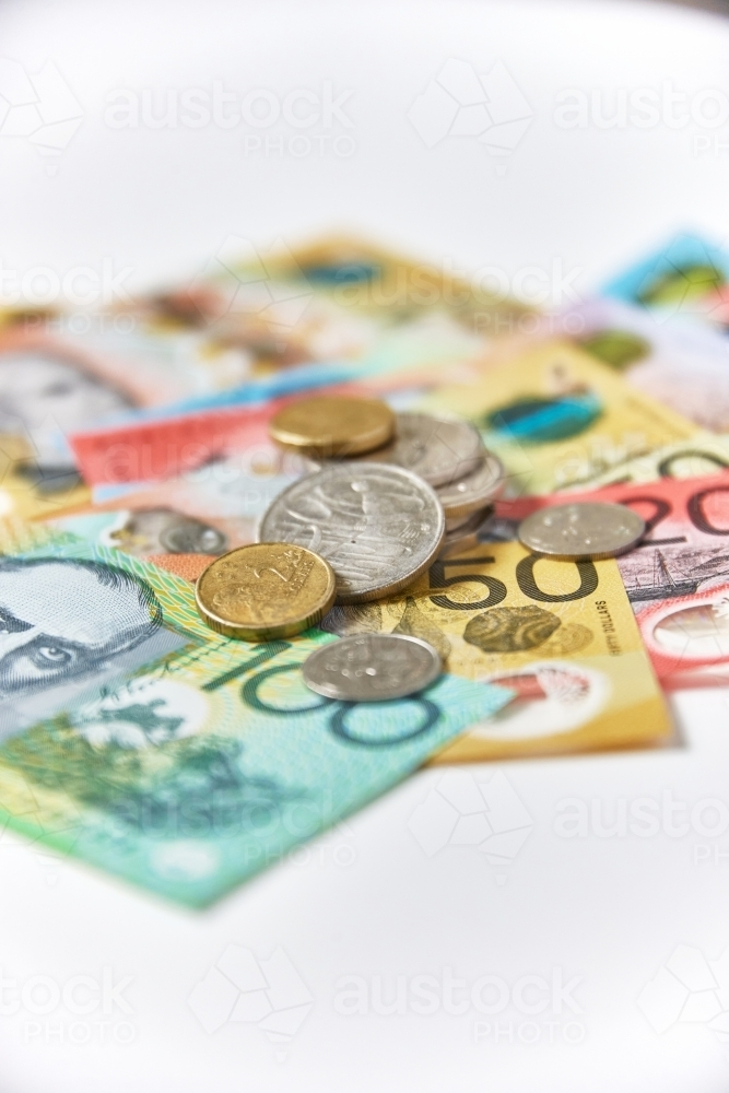 Image of Collection of Australian banknotes and coins scattered on a ...