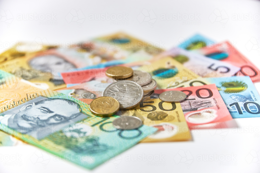 Image of Collection of Australian banknotes and coins scattered on a ...