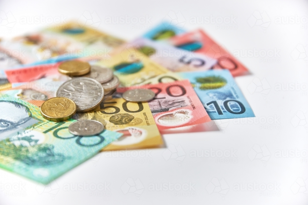 Image of Collection of Australian banknotes and coins scattered on a ...