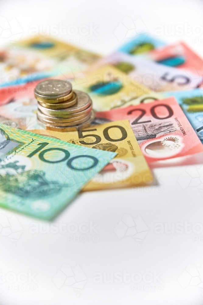 Image of Collection of Australian banknotes and coins scattered on a ...