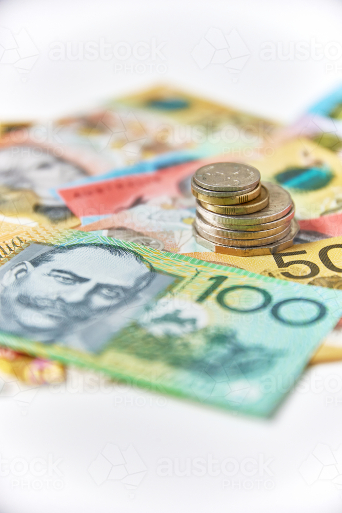 Image of Collection of Australian banknotes and coins scattered on a ...
