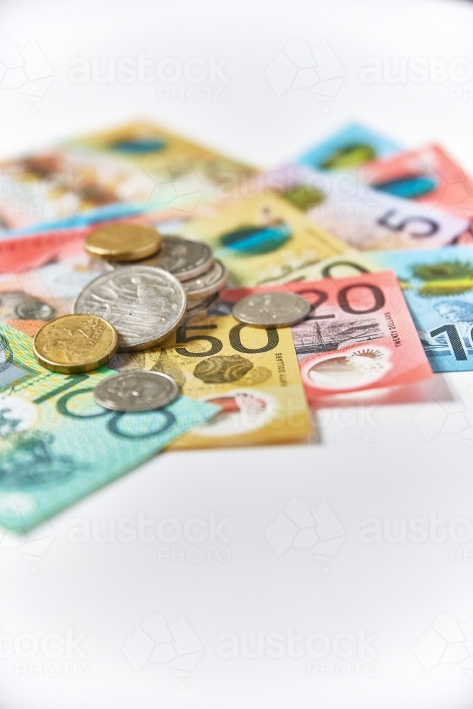 Image of Collection of Australian banknotes and coins scattered on a ...