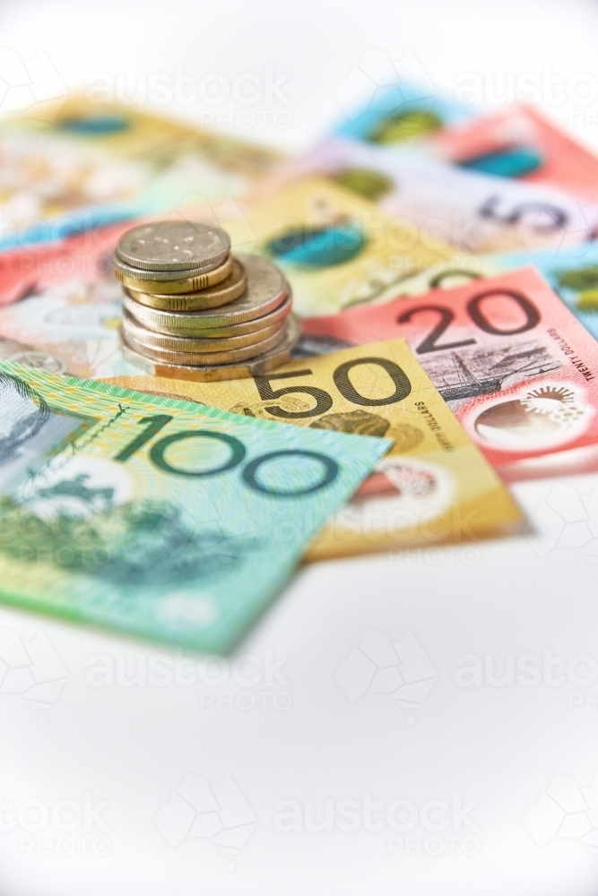 Image of Collection of Australian banknotes and coins scattered on a ...