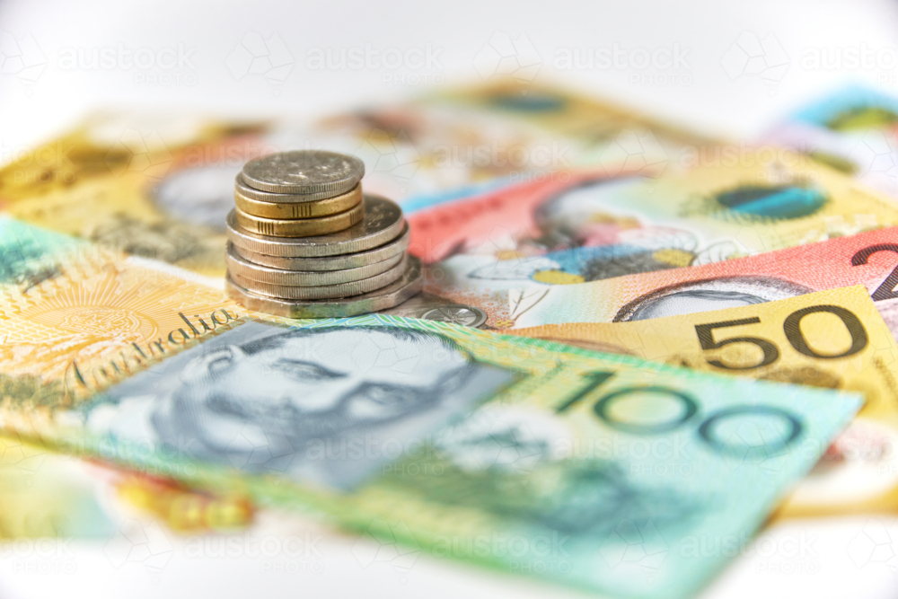 Image of Collection of Australian banknotes and coins scattered on a ...