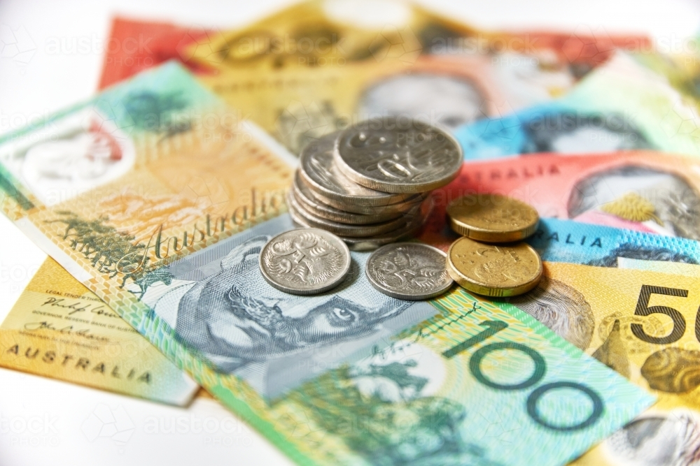 Image of Collection of Australian banknotes and coins scattered on a ...