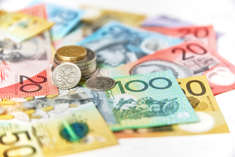 Image of Collection of Australian banknotes and coins scattered on a ...