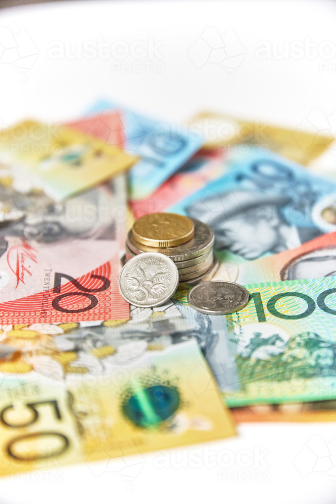 Image of Collection of Australian banknotes and coins scattered on a ...