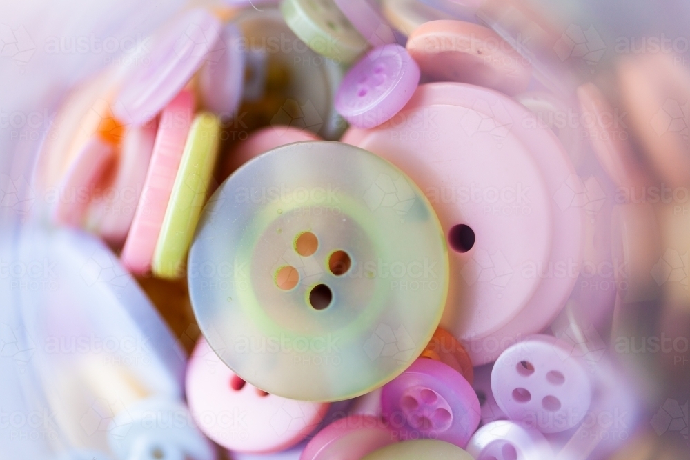 Image of Collection of pastel buttons in jar close up - Austockphoto
