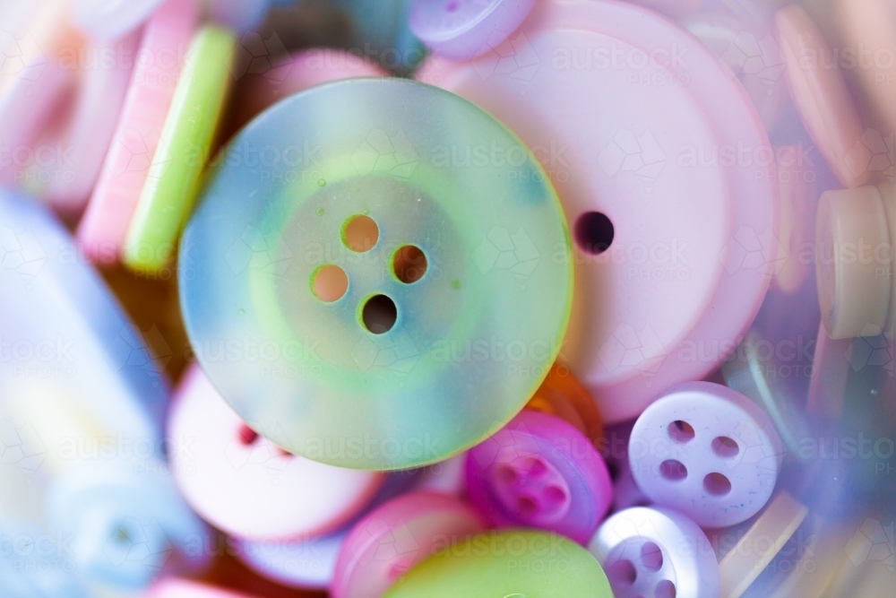 Image of Collection of pastel buttons in jar close up - Austockphoto