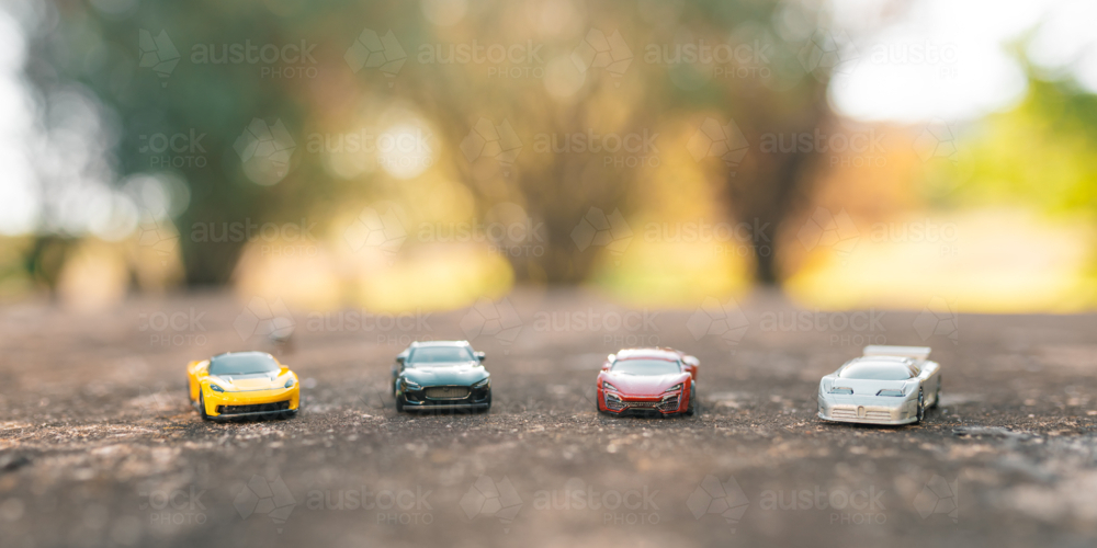 Image of Collection of small toy cars outdoors with bokeh background ...