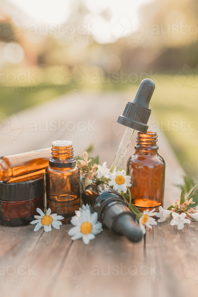 Image of Collection of various amber essential oil bottles in natural ...