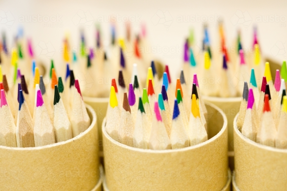 Image of Coloured pencils in pencil pots - Austockphoto