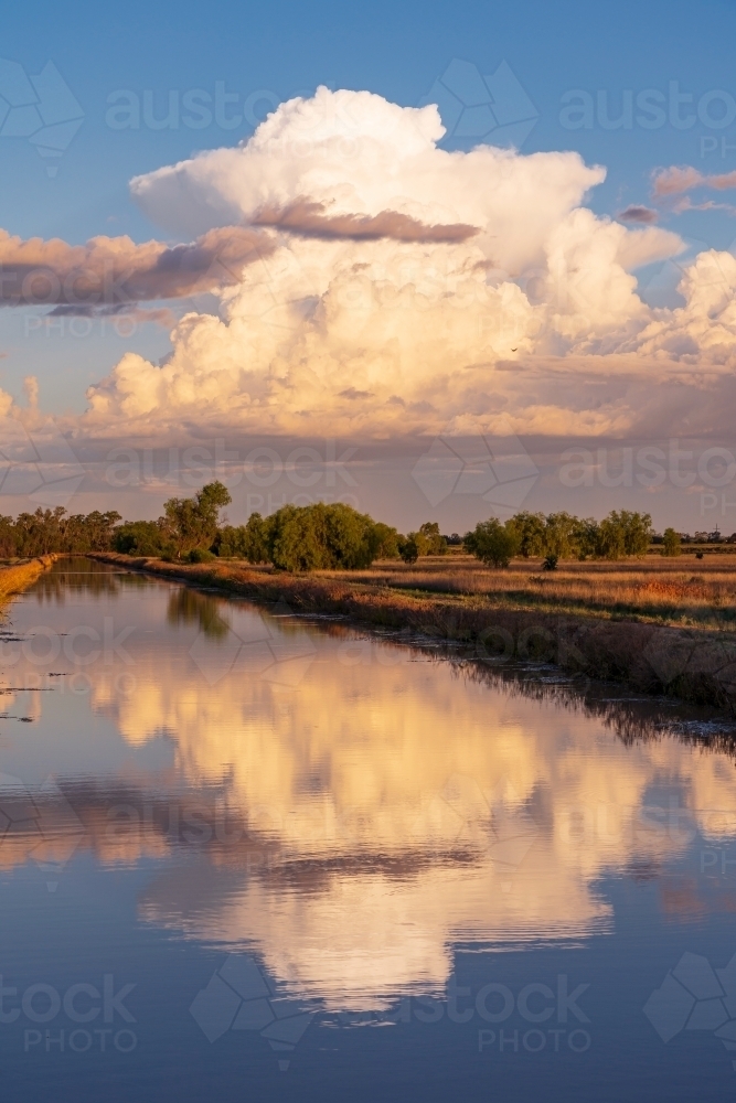 Image of Colourful storm clouds at twilight reflected in the water of ...