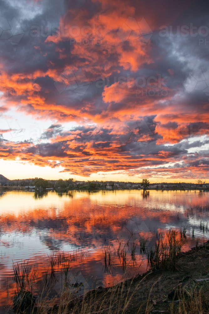 Image of Colourful sunset over a country dam - Austockphoto