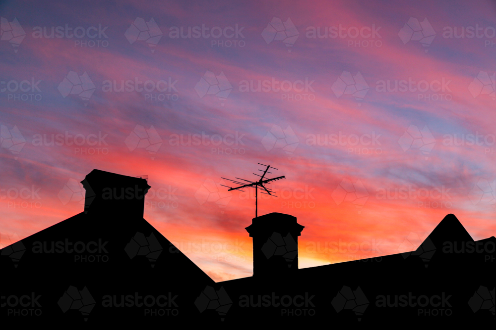 Image of Colourful sunset over suburban Sydney roof. - Austockphoto