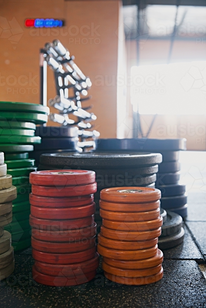 Image of Colourful weights in an indoor gym - Austockphoto