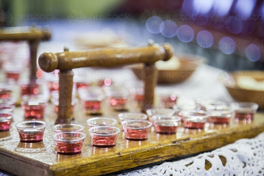 Image of Communion cups of juice in trays and bread for a church ...