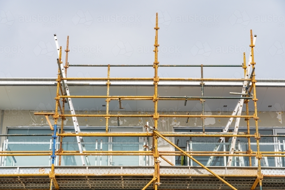 Image of Construction scaffolding up the side of a high rise building ...